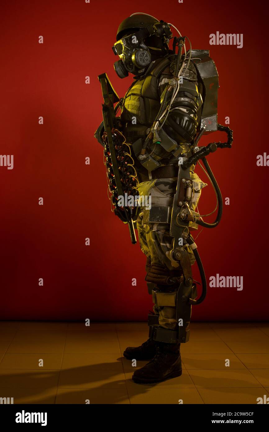 Actor man in a military helmet, mask and uniform with a gauss rifle in ...