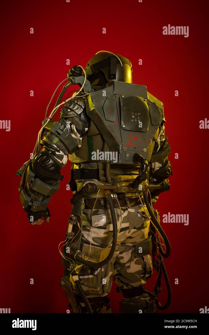 Actor man in a military helmet, mask and uniform with a gauss rifle in ...