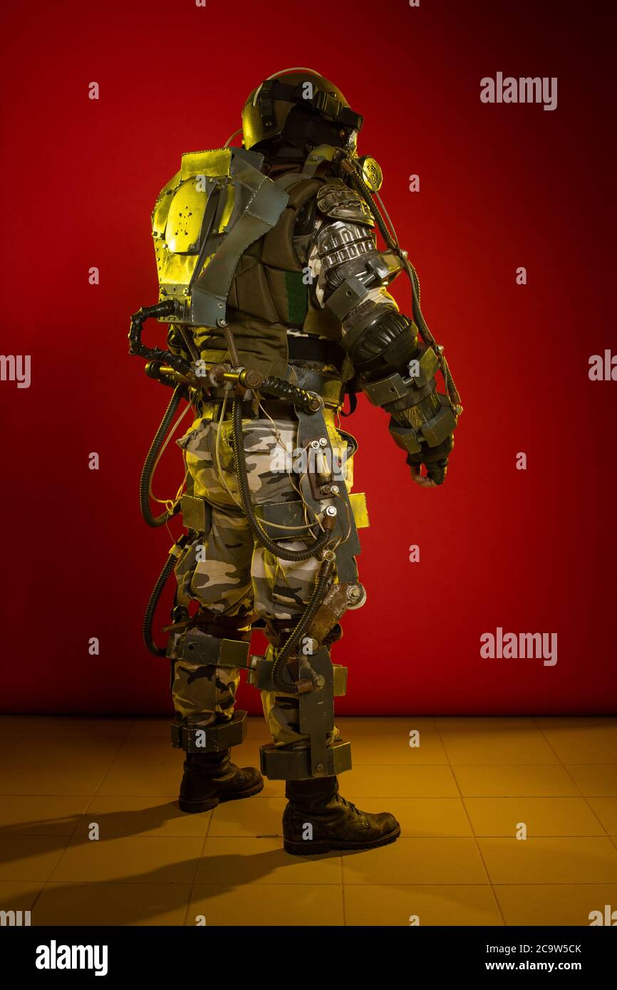 Actor man in a military helmet, mask and uniform with a gauss rifle in ...