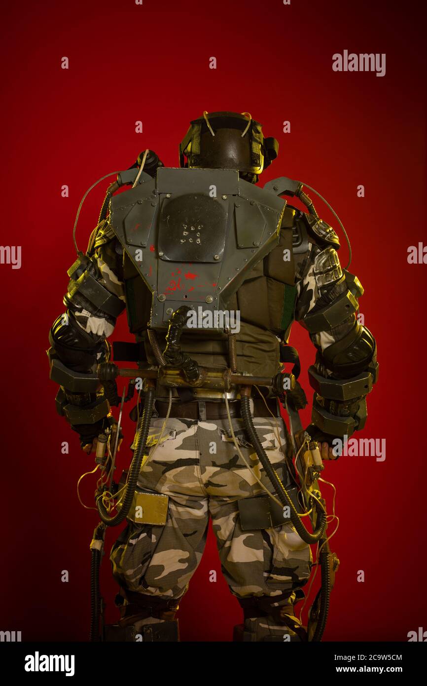 Actor man in a military helmet, mask and uniform with a gauss rifle in ...