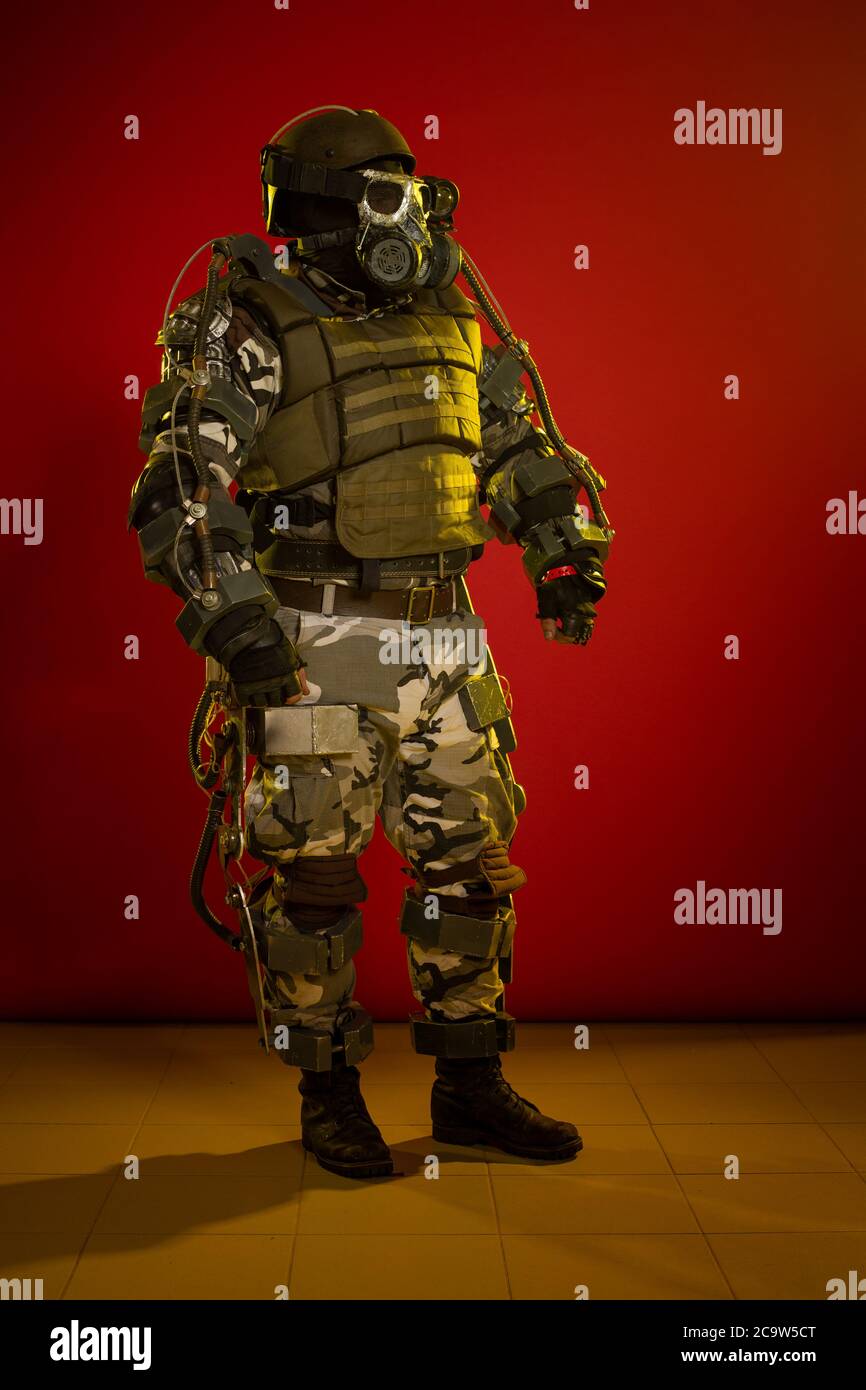 Actor man in a military helmet, mask and uniform with a gauss rifle in ...