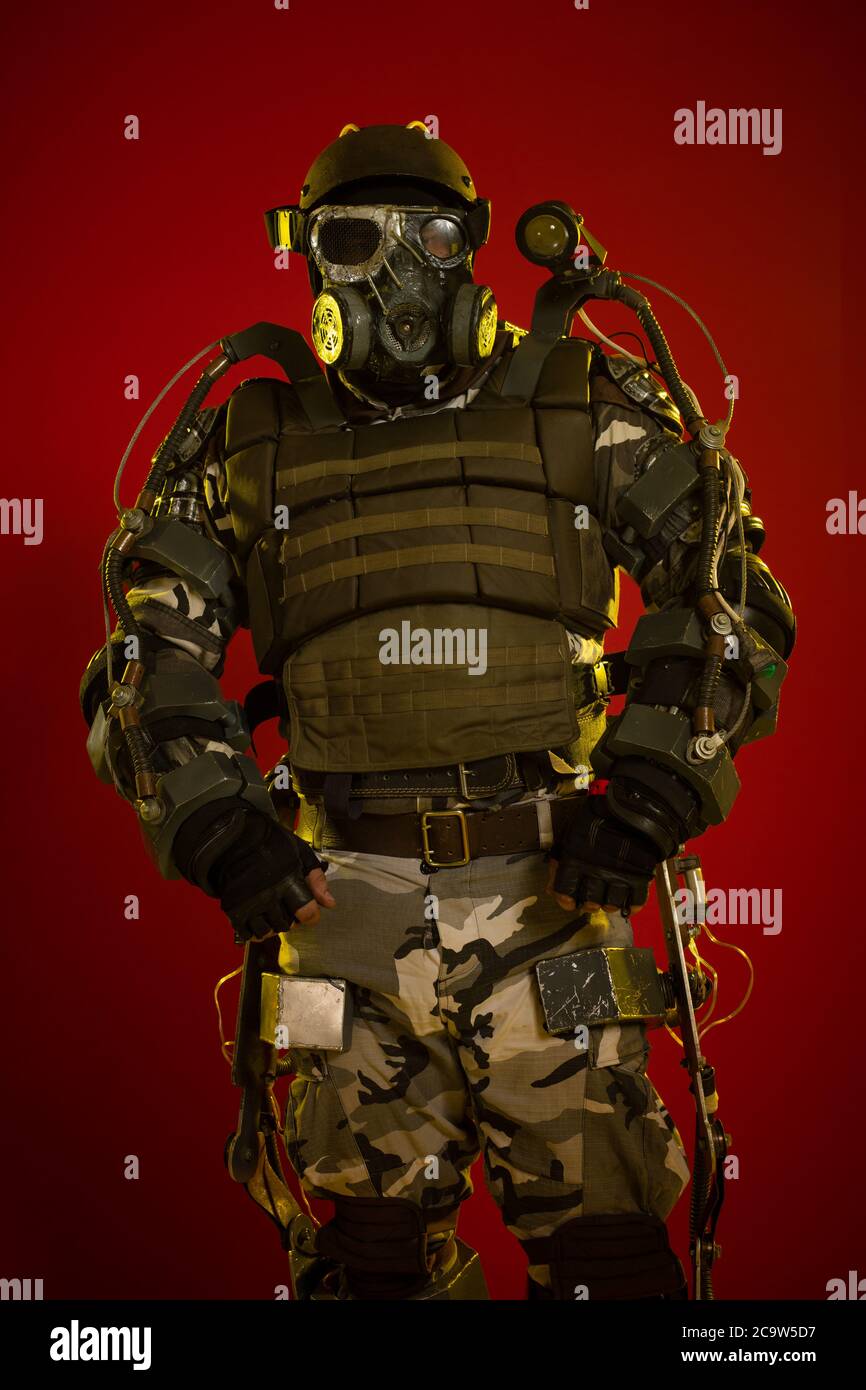 Actor man in a military helmet, mask and uniform with a gauss rifle in ...