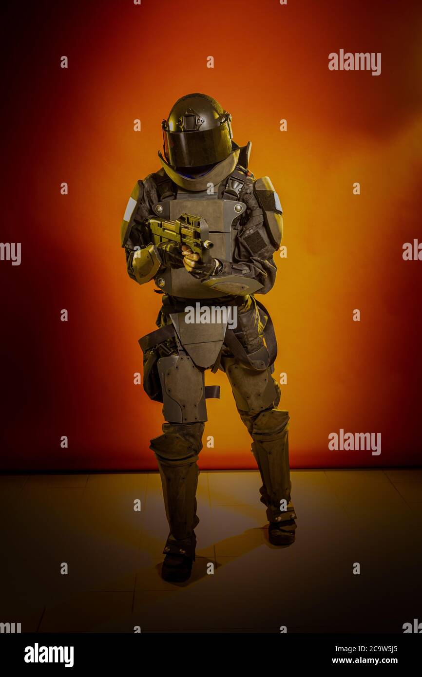 Actor man in a military helmet, mask and uniform with a gauss rifle in ...