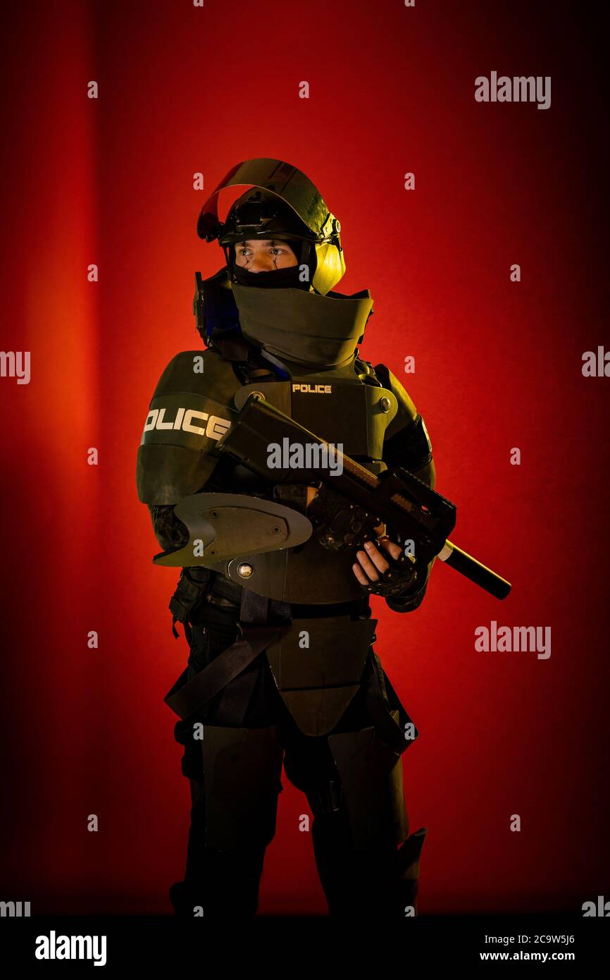 Actor man in a military helmet, mask and uniform with a gauss rifle in ...