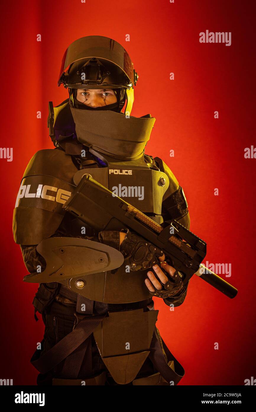 Actor man in a military helmet, mask and uniform with a gauss rifle in ...