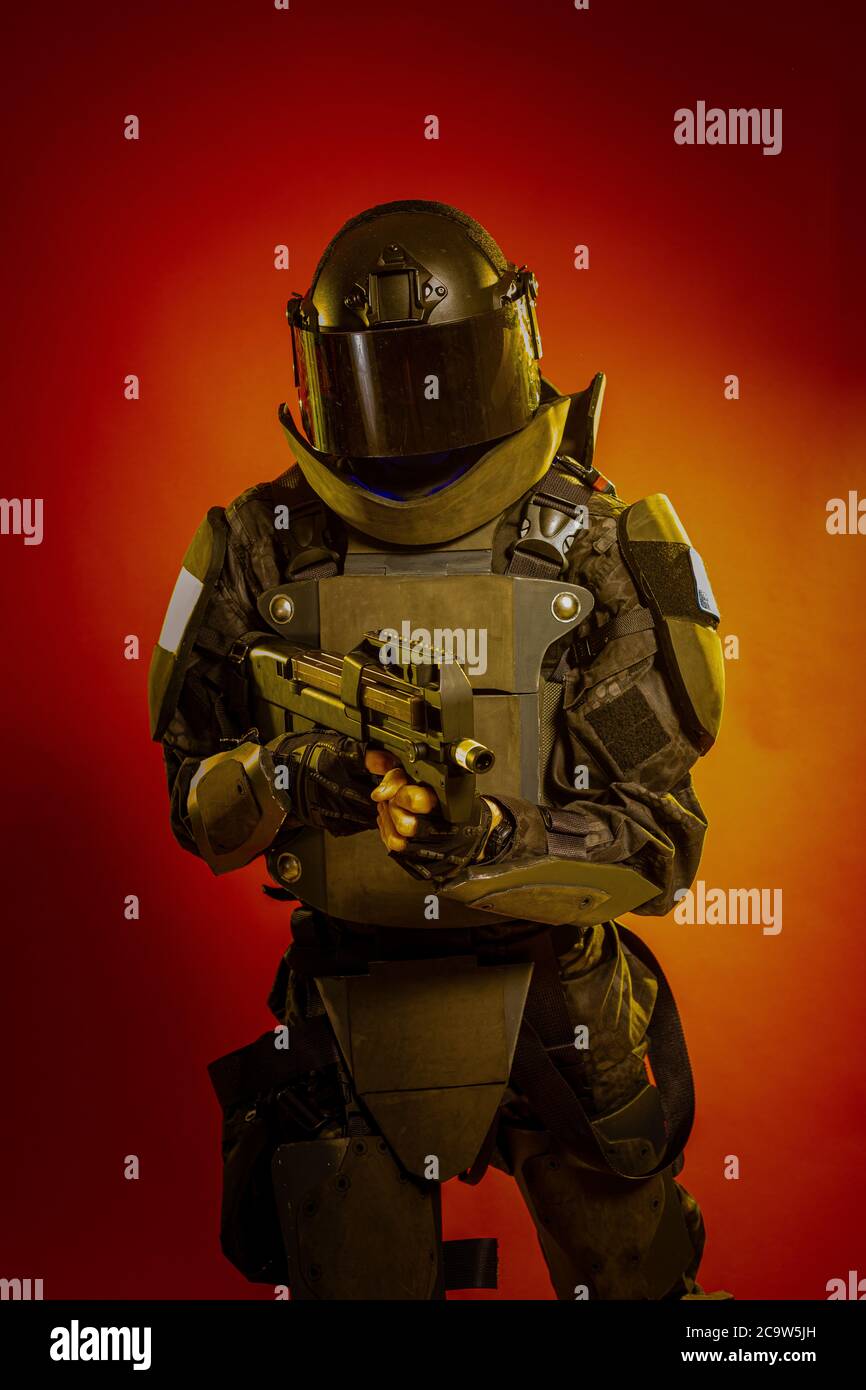 Actor man in a military helmet, mask and uniform with a gauss rifle in ...