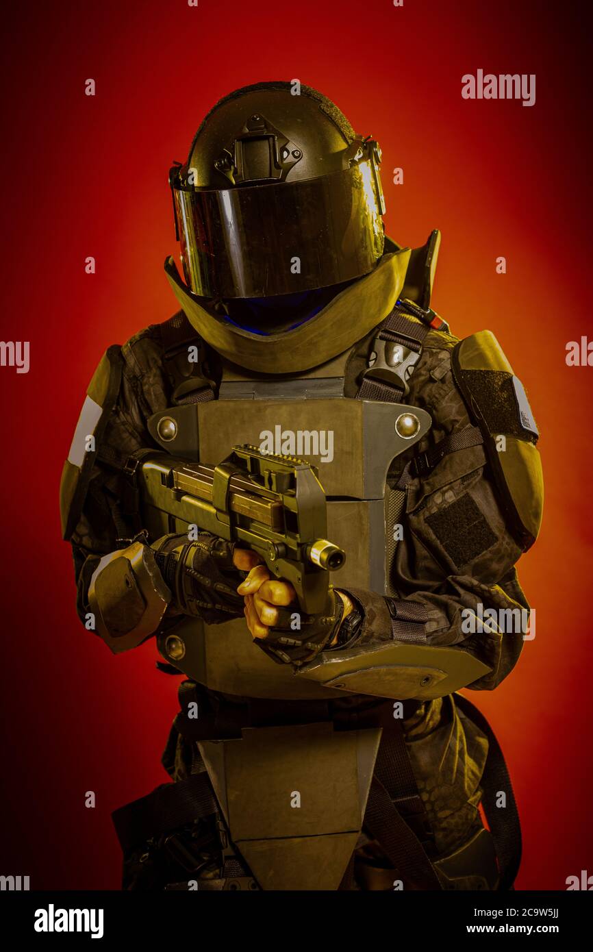 Actor man in a military helmet, mask and uniform with a gauss rifle in ...