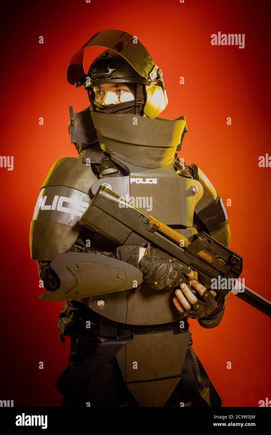 Actor man in a military helmet, mask and uniform with a gauss rifle in ...