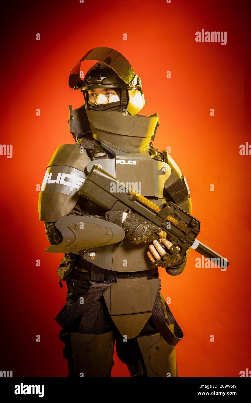 Actor man in a military helmet, mask and uniform with a gauss rifle in ...