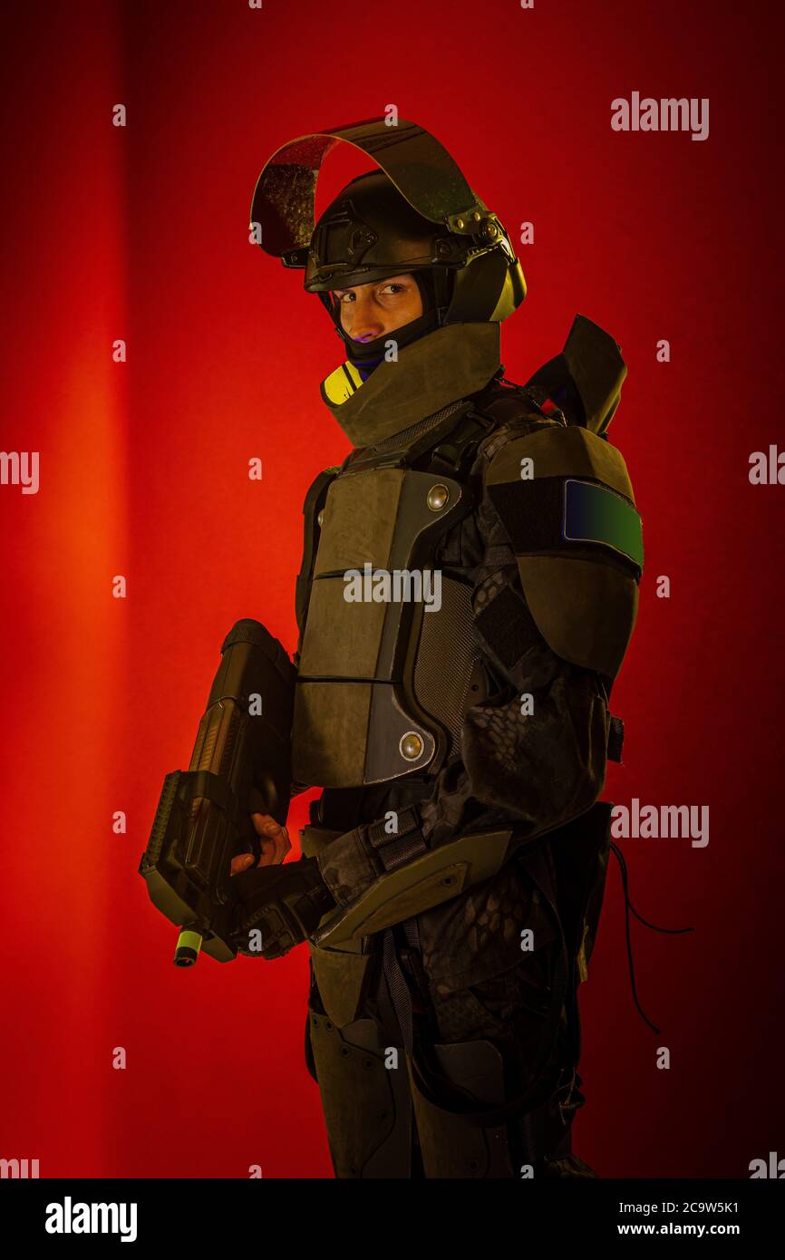 Actor man in a military helmet, mask and uniform with a gauss rifle in ...