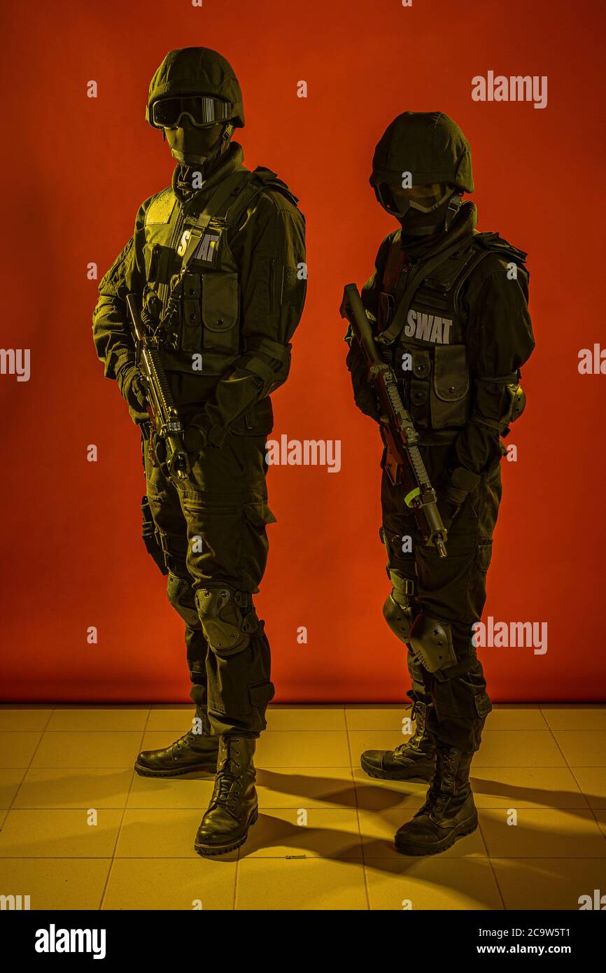 Actor man in a military helmet, mask and uniform with a gauss rifle in ...