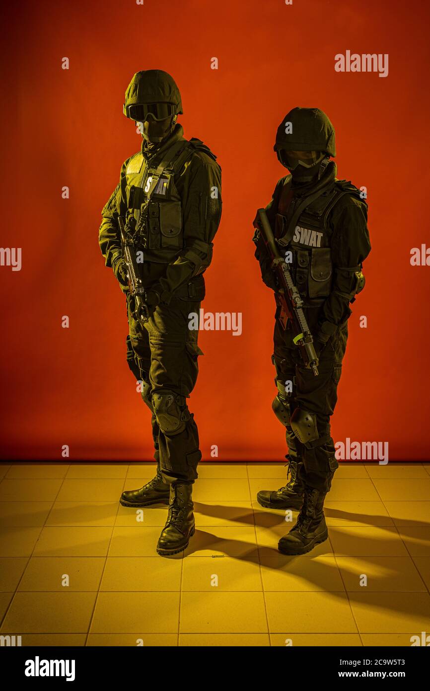 Actor man in a military helmet, mask and uniform with a gauss rifle in ...