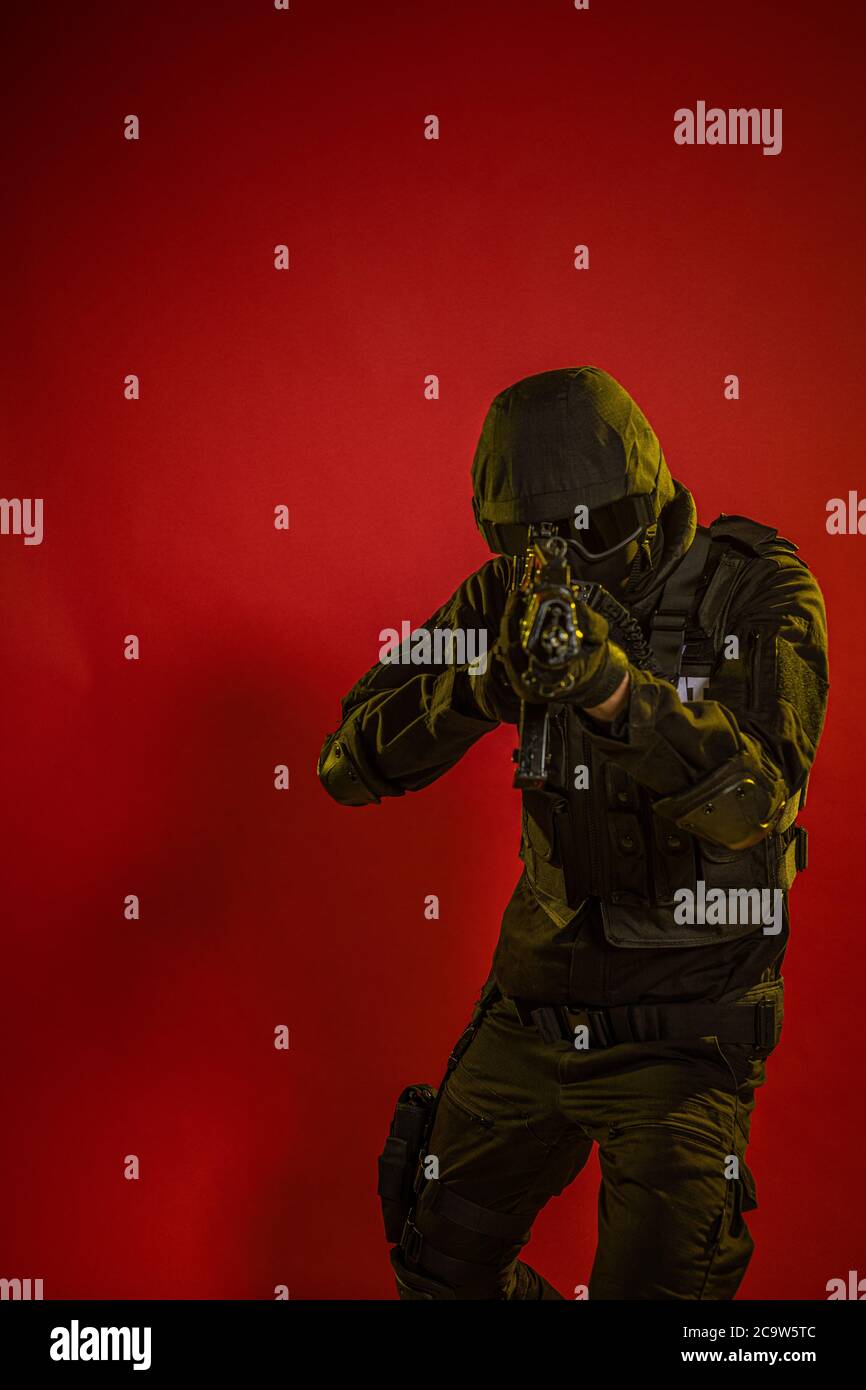 Actor man in a military helmet, mask and uniform with a gauss rifle in ...