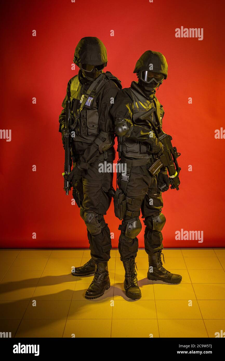 Actor man in a military helmet, mask and uniform with a gauss rifle in ...