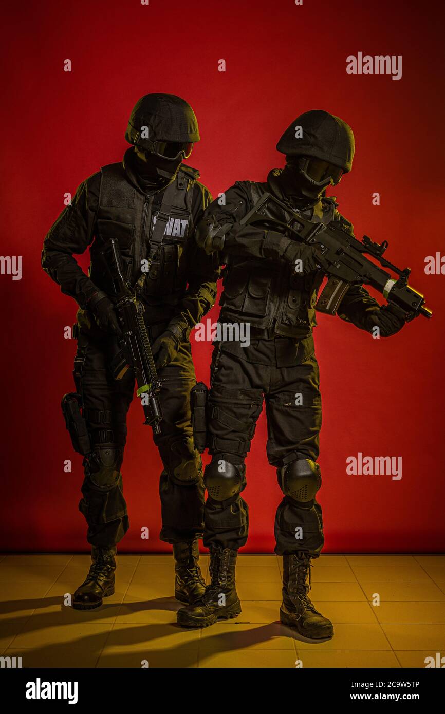 Actor man in a military helmet, mask and uniform with a gauss rifle in ...