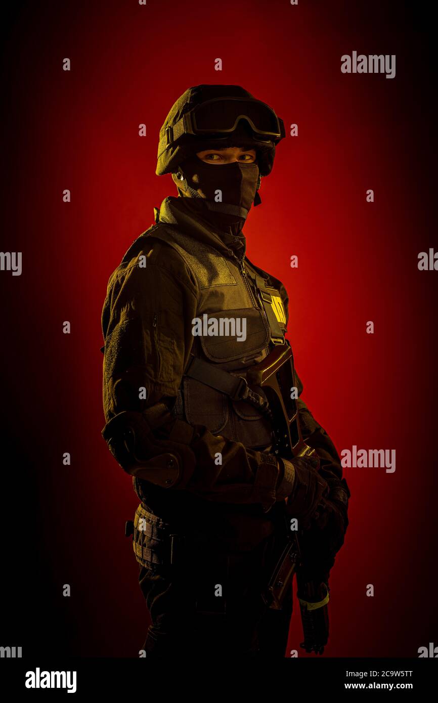 Actor man in a military helmet, mask and uniform with a gauss rifle in ...