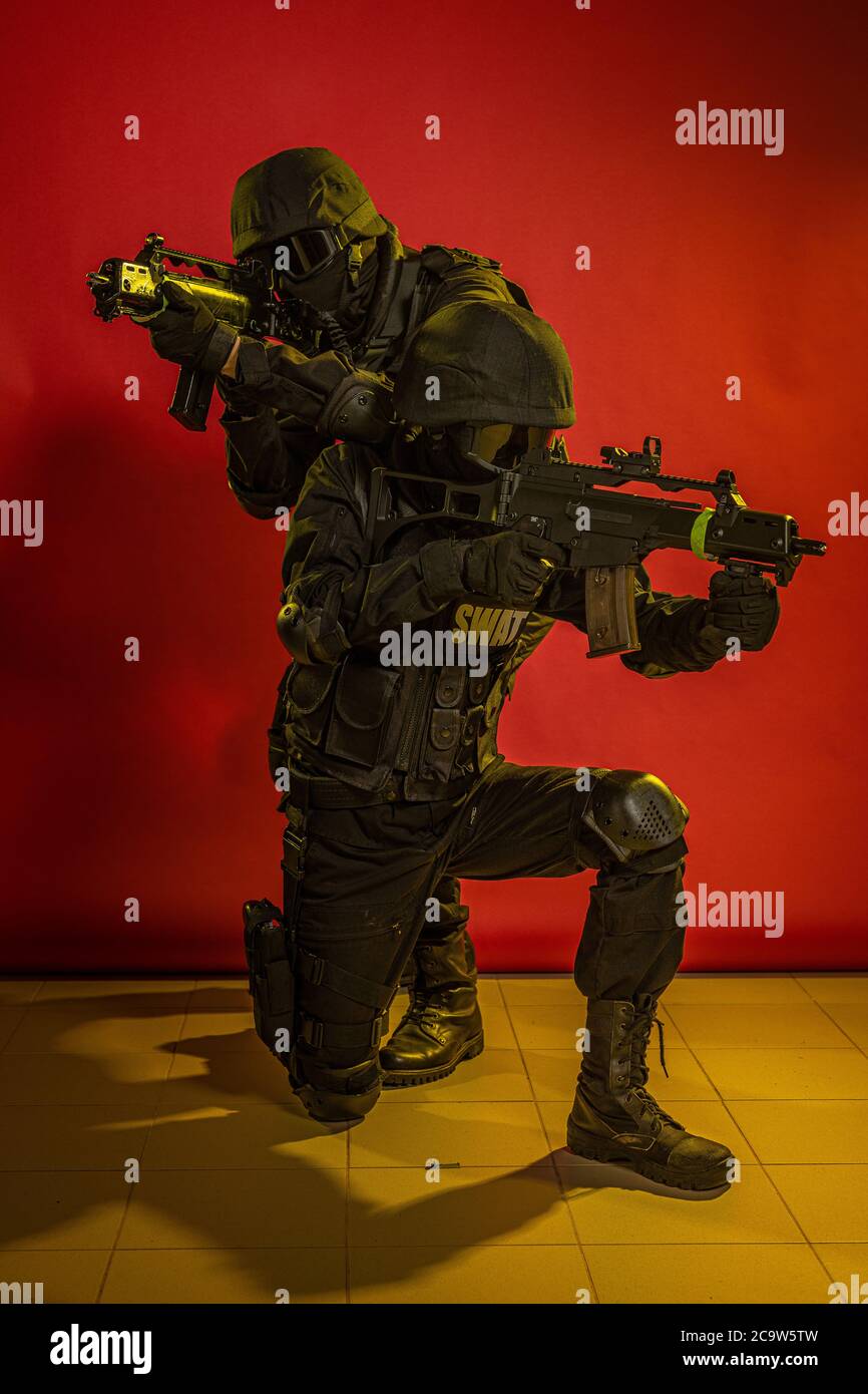 Actor man in a military helmet, mask and uniform with a gauss rifle in ...