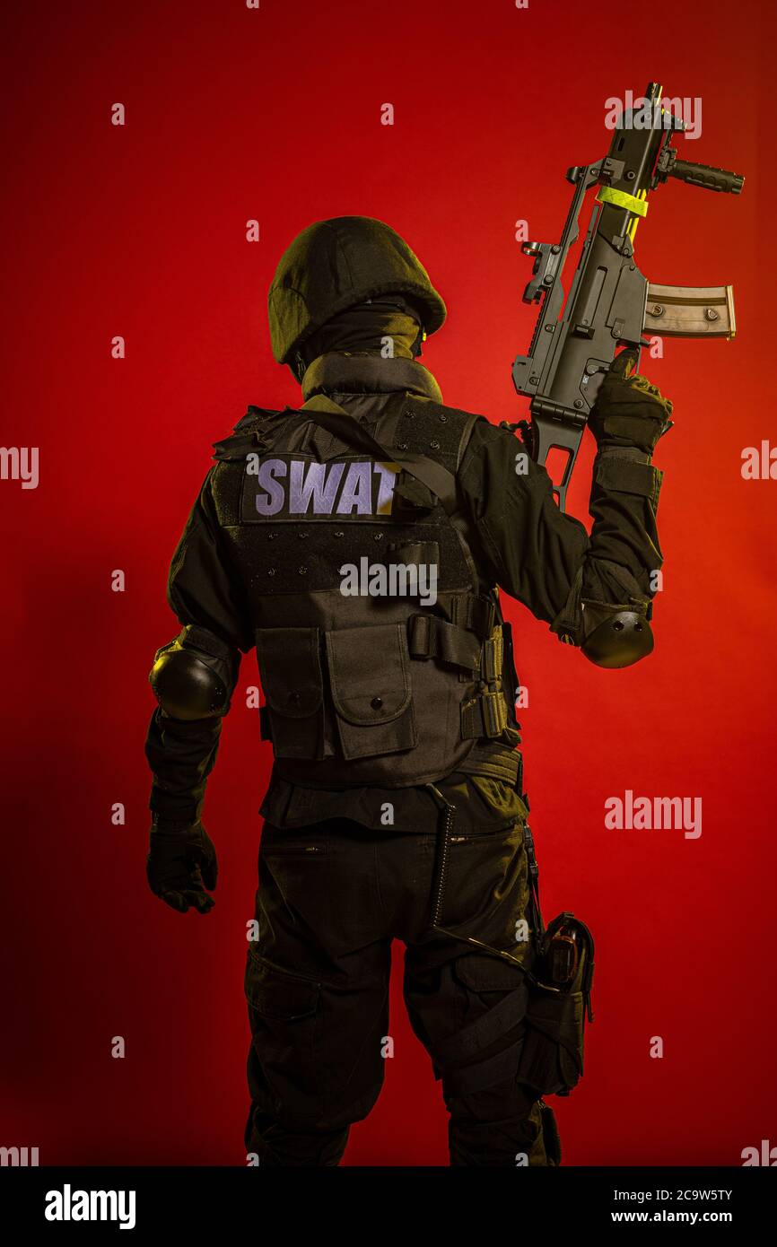 Actor man in a military helmet, mask and uniform with a gauss rifle in ...