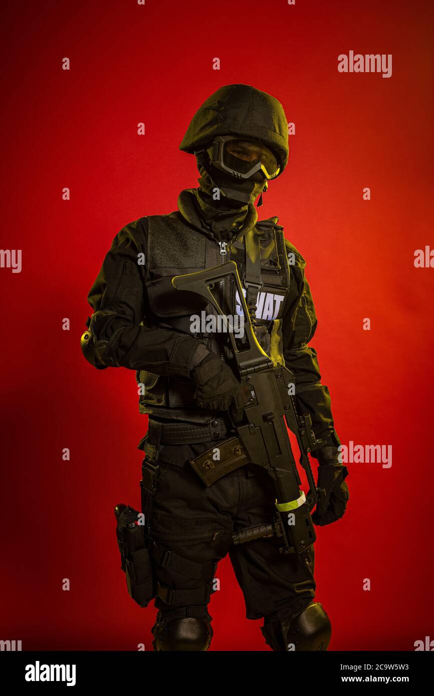 Actor man in a military helmet, mask and uniform with a gauss rifle in ...