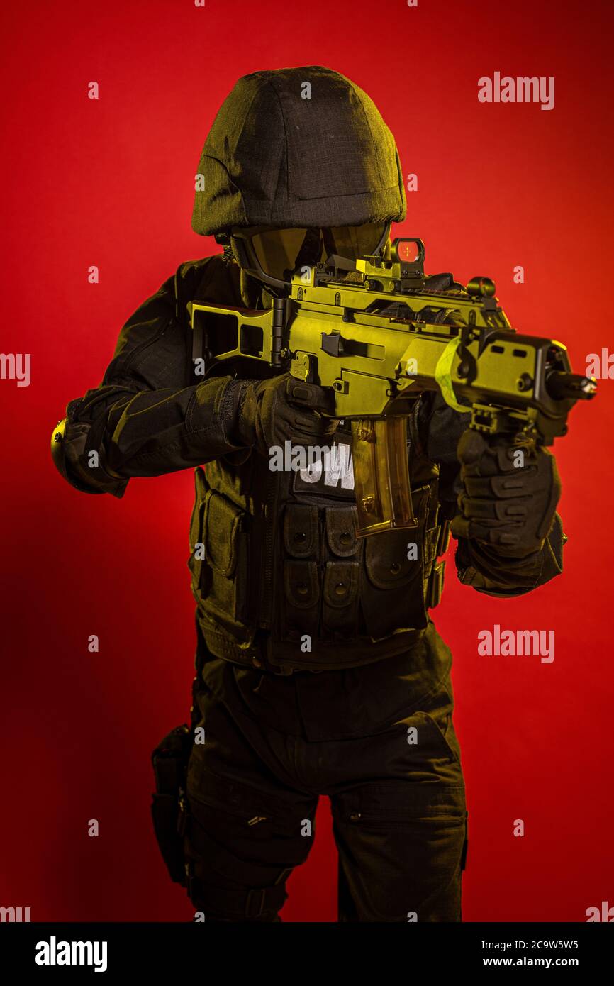 Actor man in a military helmet, mask and uniform with a gauss rifle in ...