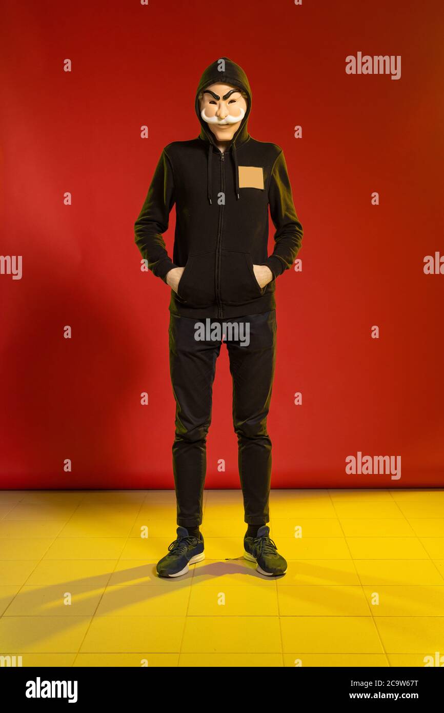 Actor man in a military helmet, mask and uniform posing on a red ...