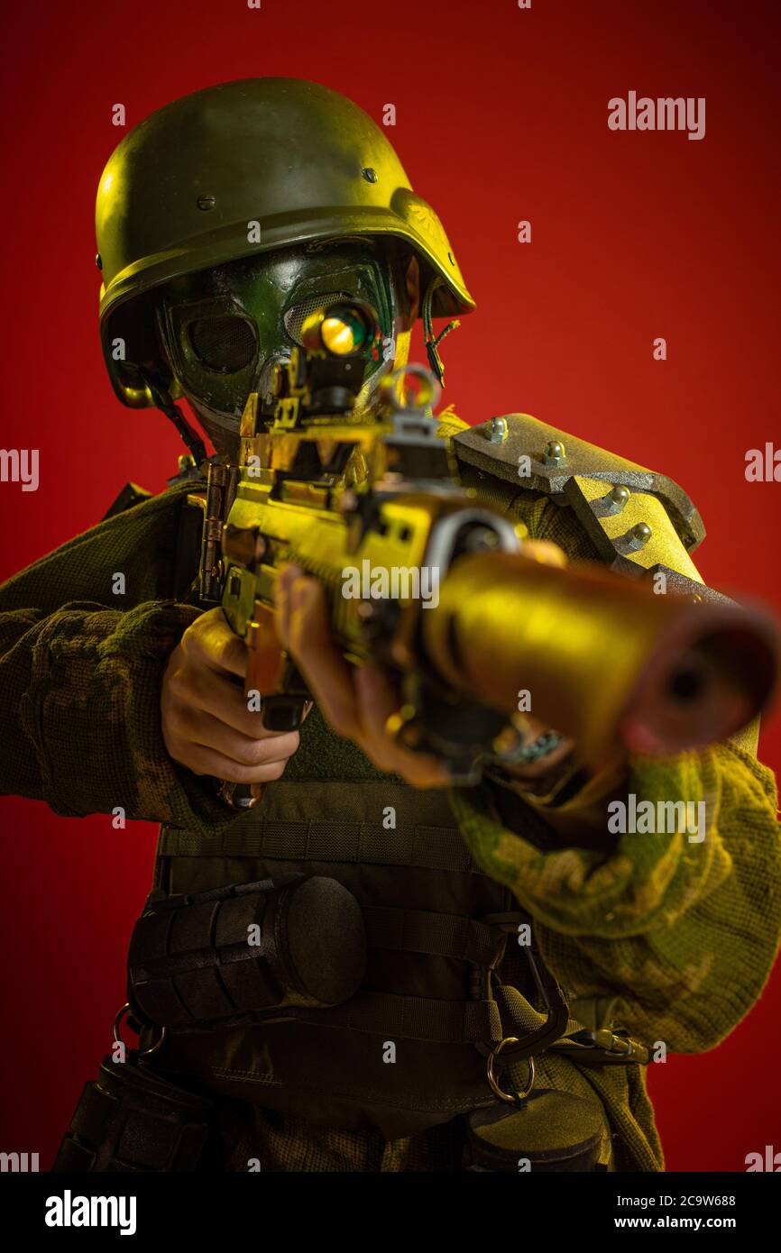 Actor man in a military helmet, mask and uniform posing on a red ...