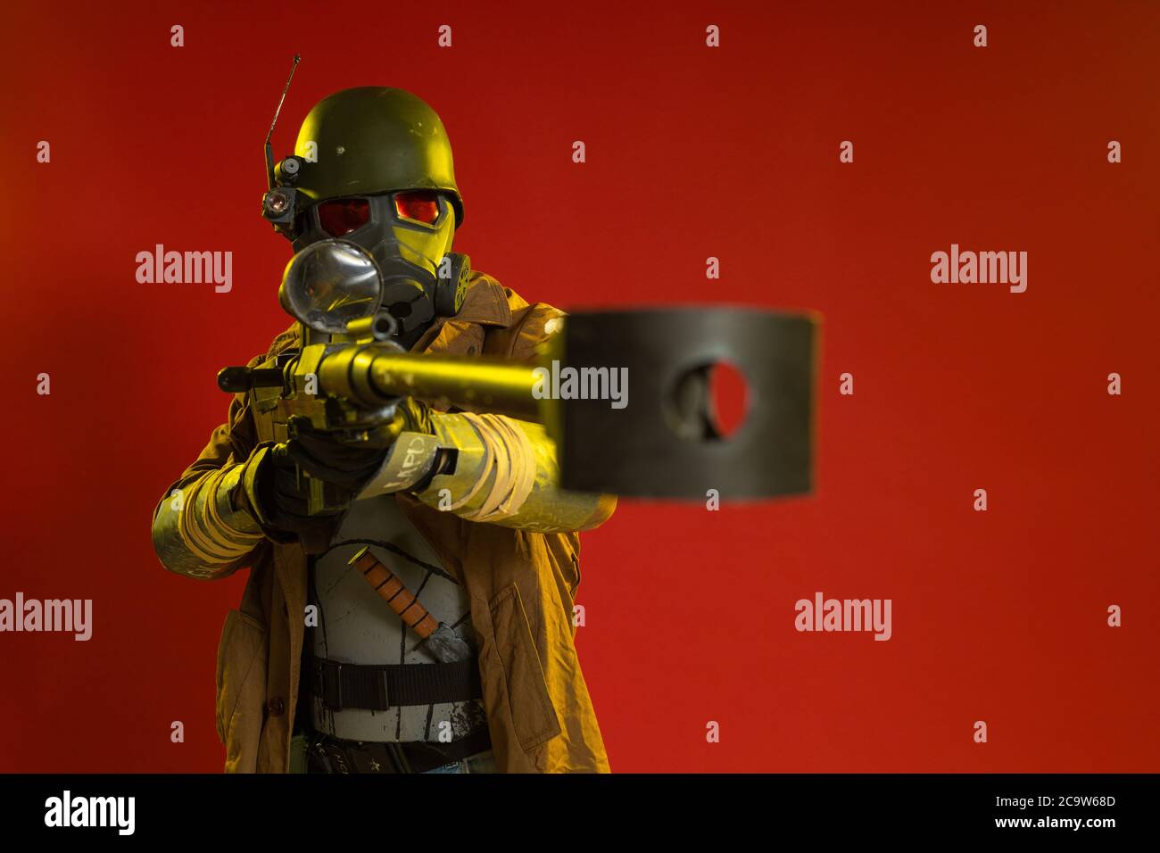 Actor man in a military helmet, mask and uniform posing on a red ...