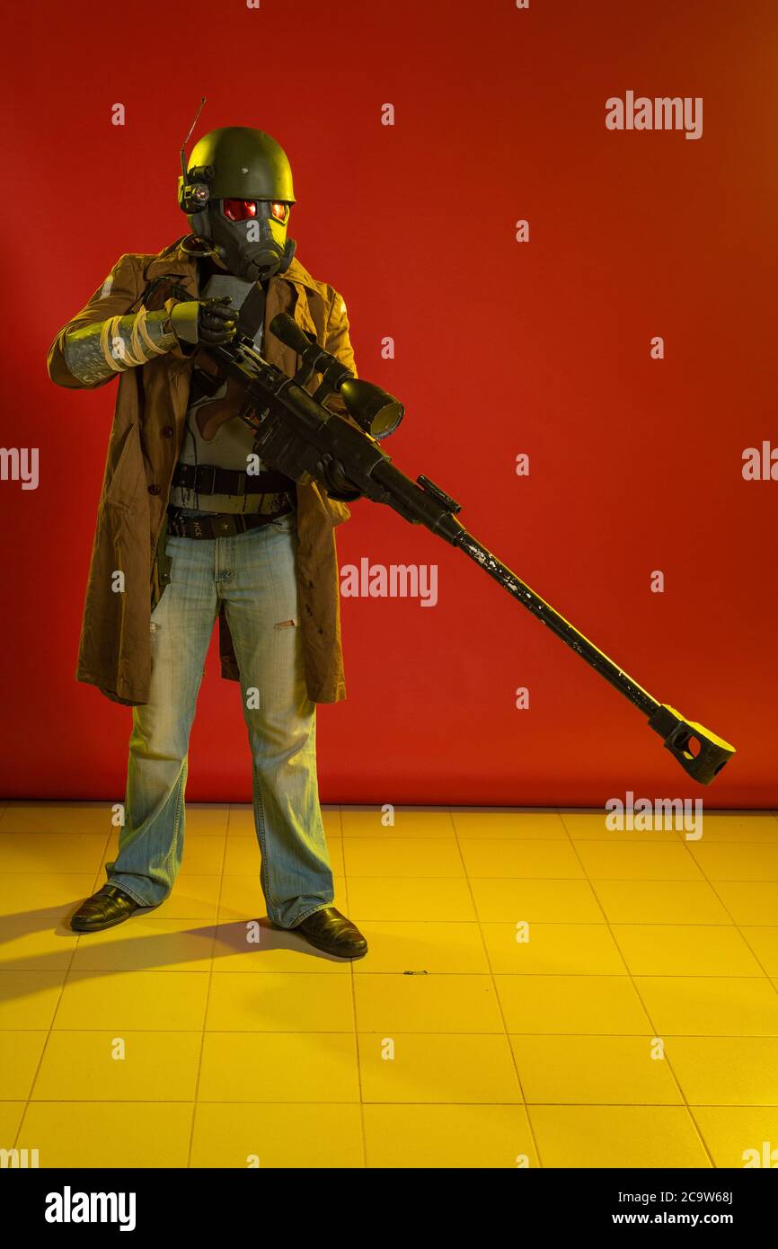 Actor man in a military helmet, mask and uniform posing on a red ...
