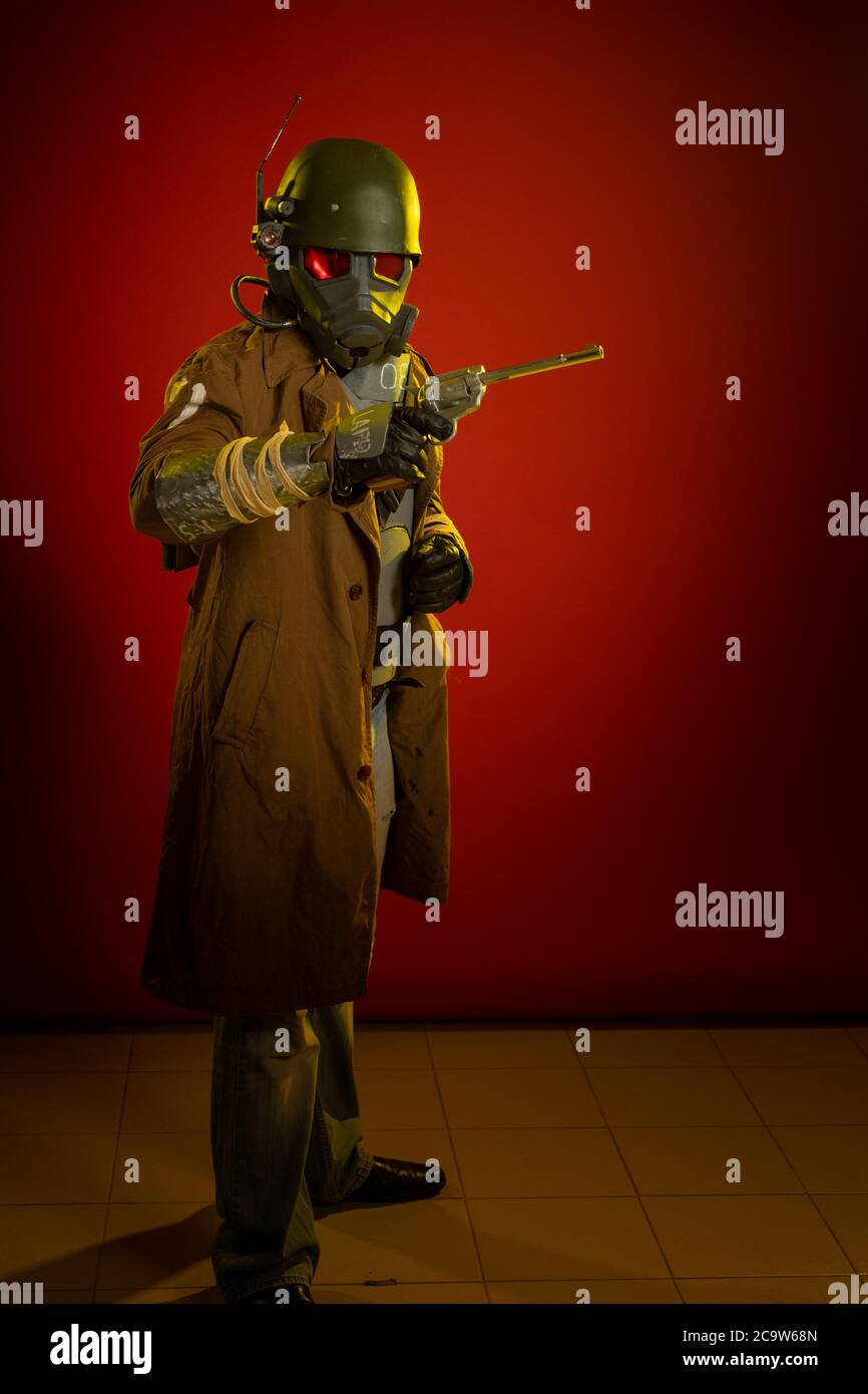 Actor man in a military helmet, mask and uniform posing on a red ...
