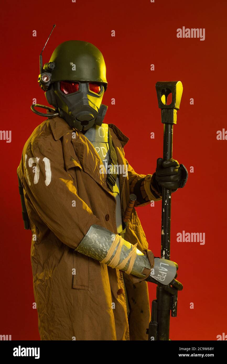 Actor man in a military helmet, mask and uniform posing on a red ...