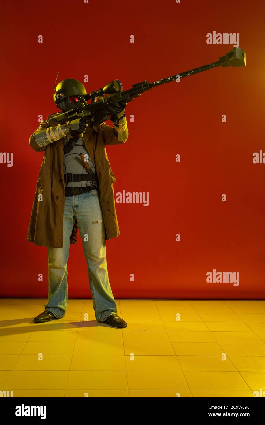 Actor man in a military helmet, mask and uniform posing on a red ...