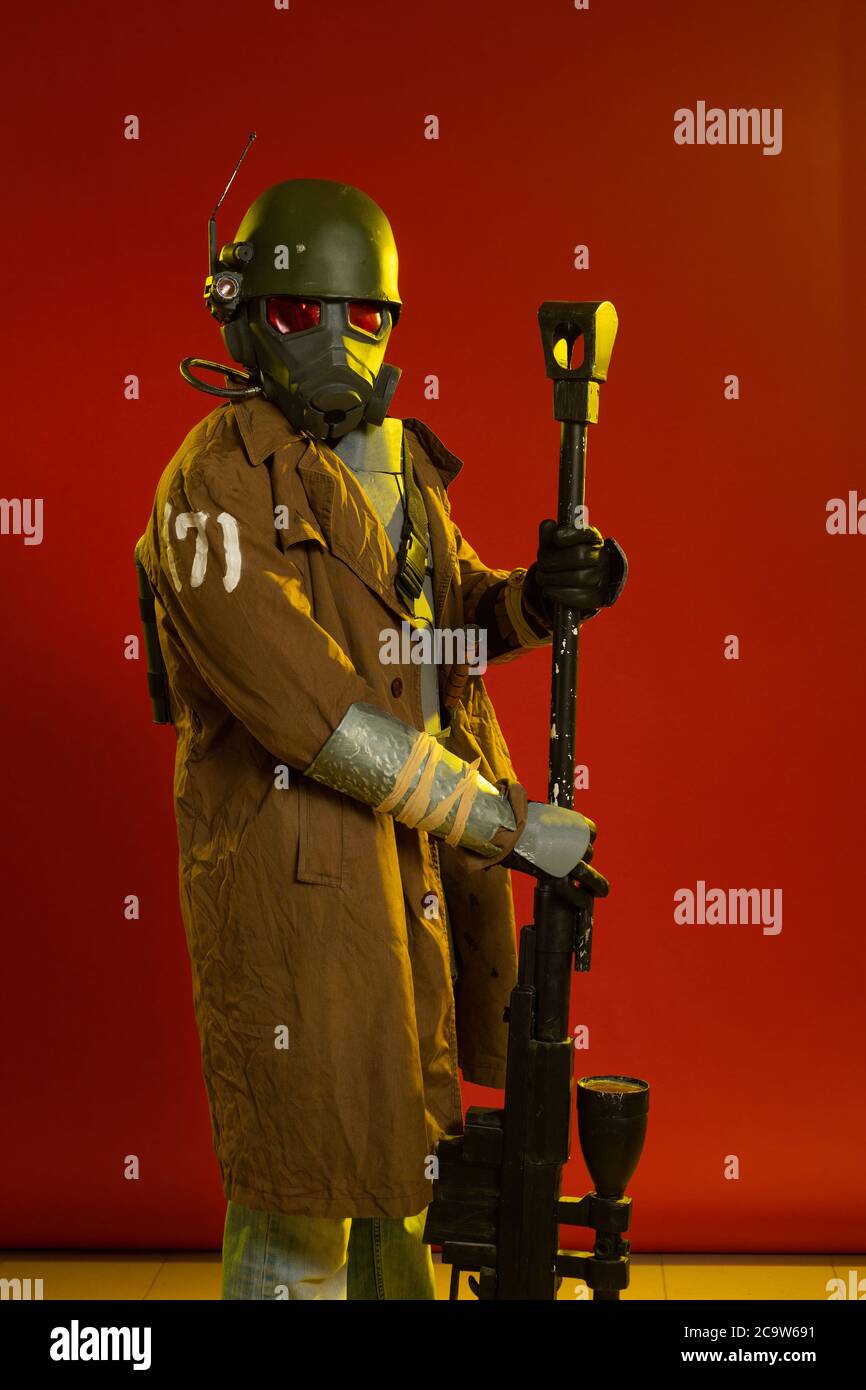 Actor man in a military helmet, mask and uniform posing on a red ...