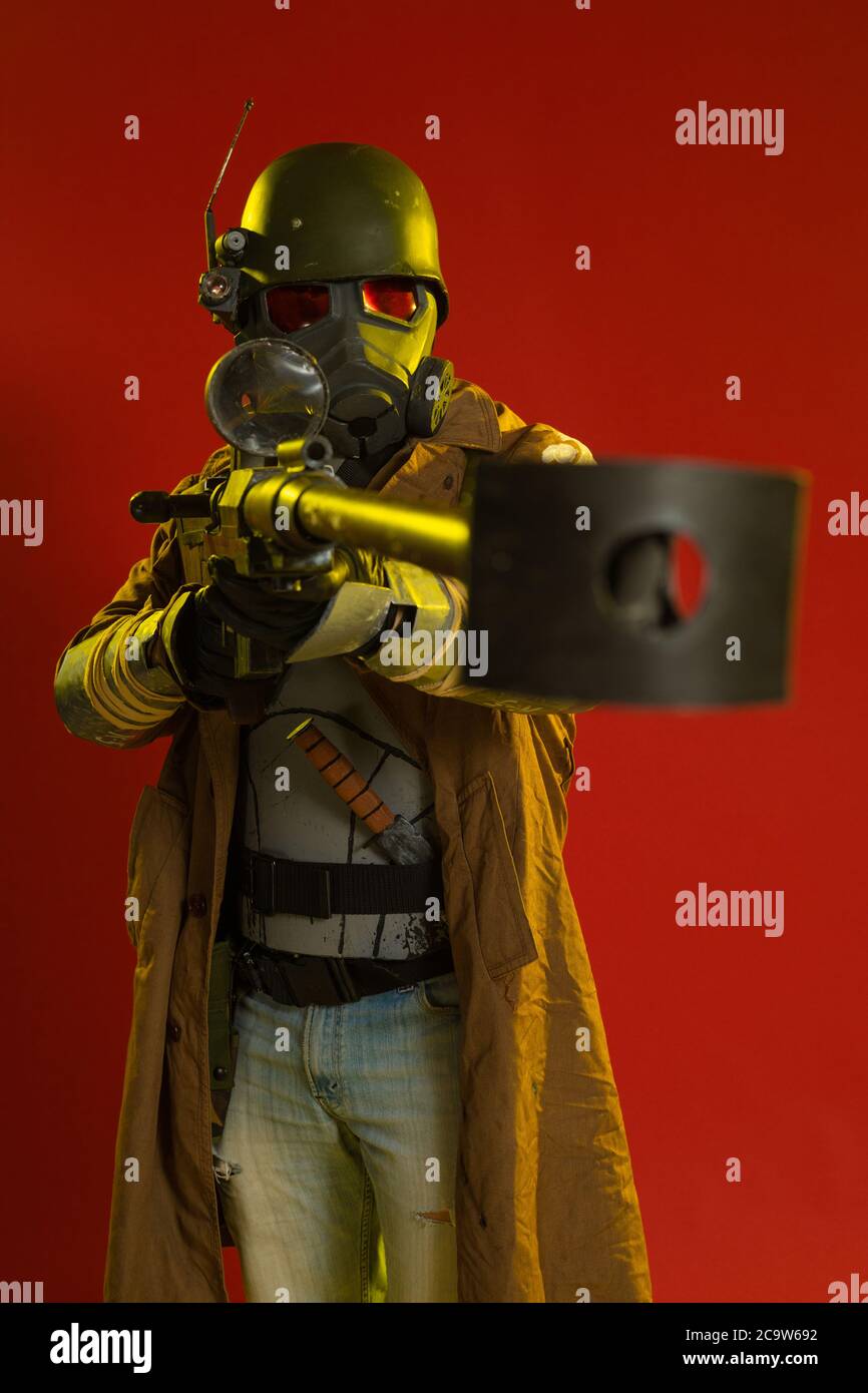Actor man in a military helmet, mask and uniform posing on a red ...