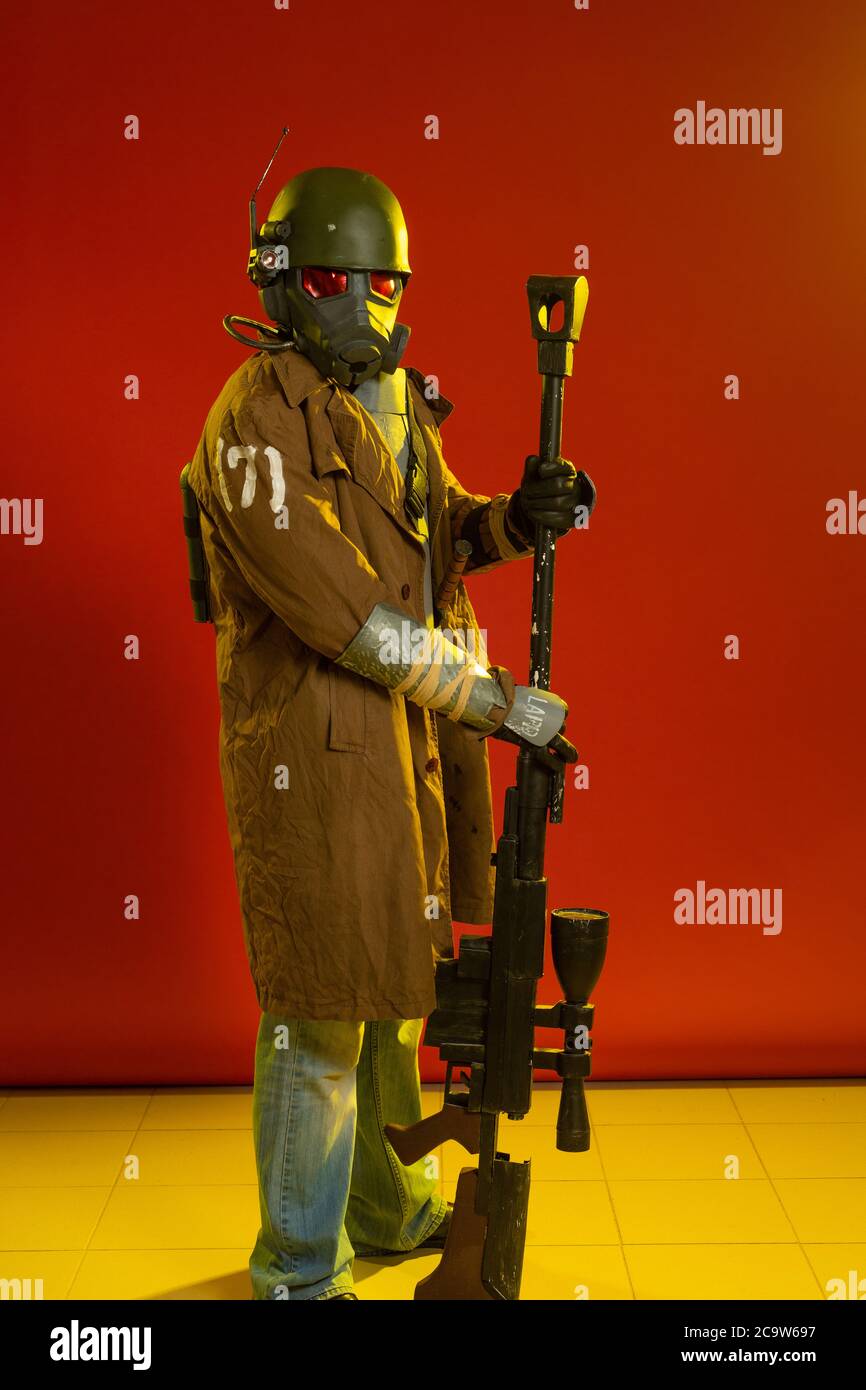 Actor man in a military helmet, mask and uniform posing on a red ...