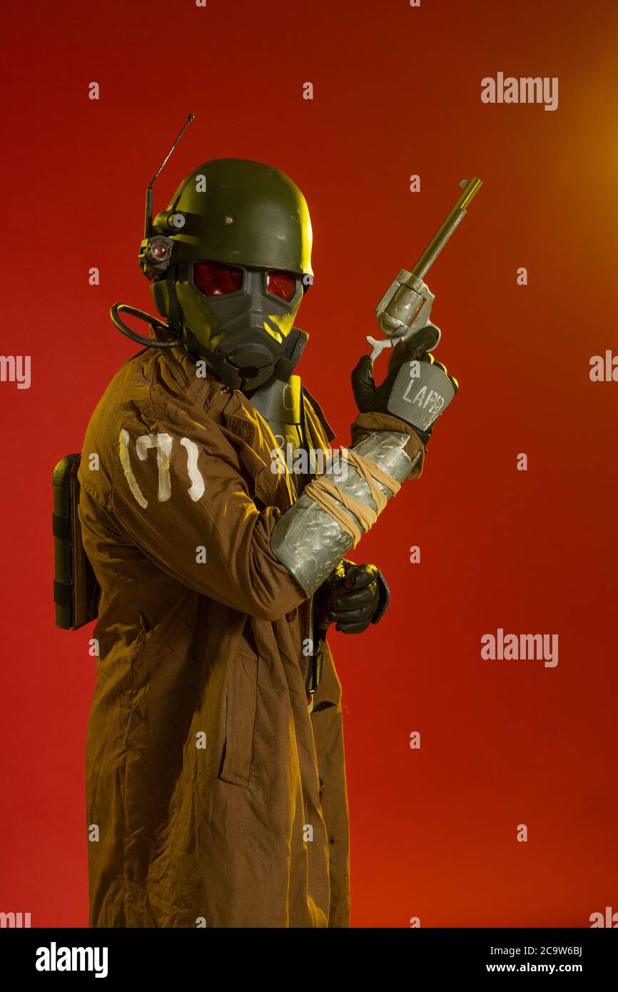 Actor man in a military helmet, mask and uniform posing on a red ...