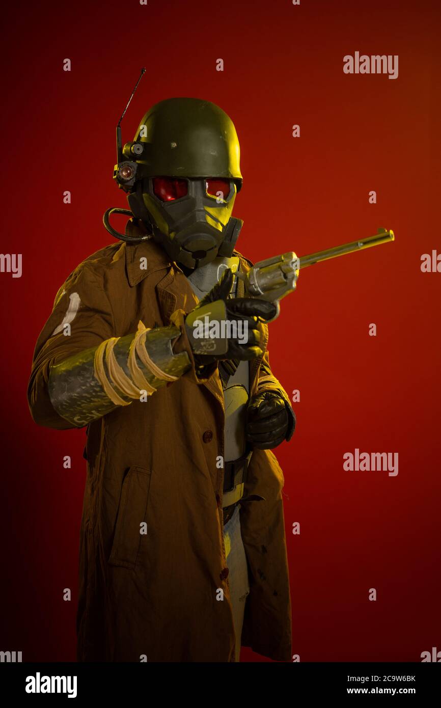 Actor man in a military helmet, mask and uniform posing on a red ...