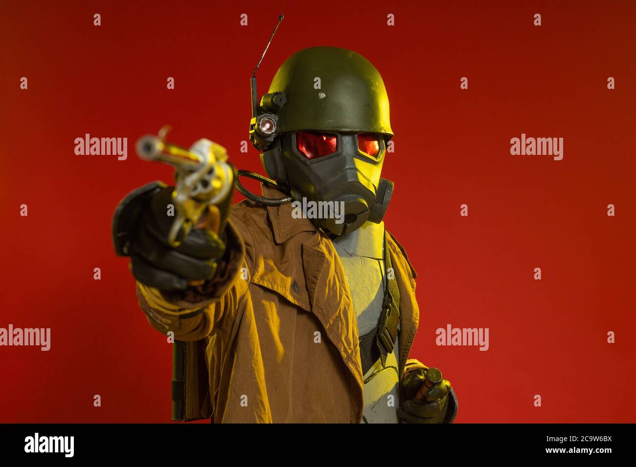 Actor man in a military helmet, mask and uniform posing on a red ...