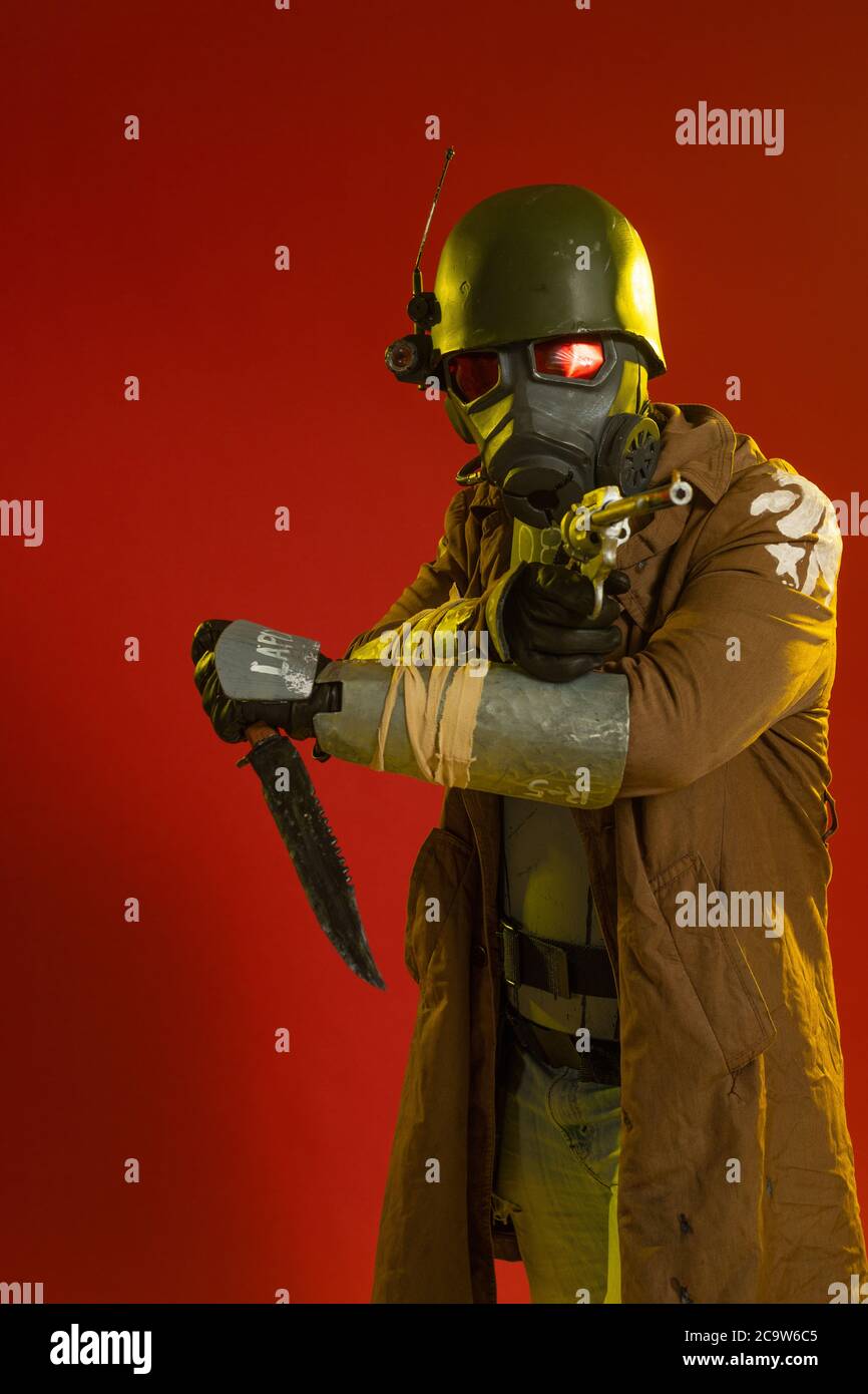 Actor man in a military helmet, mask and uniform posing on a red ...