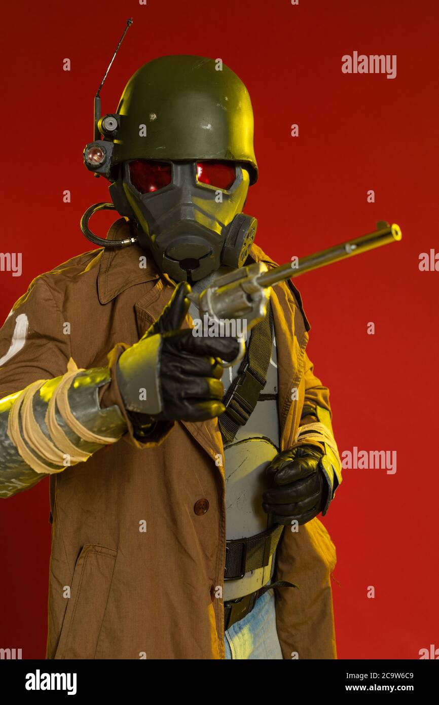 Actor man in a military helmet, mask and uniform posing on a red ...