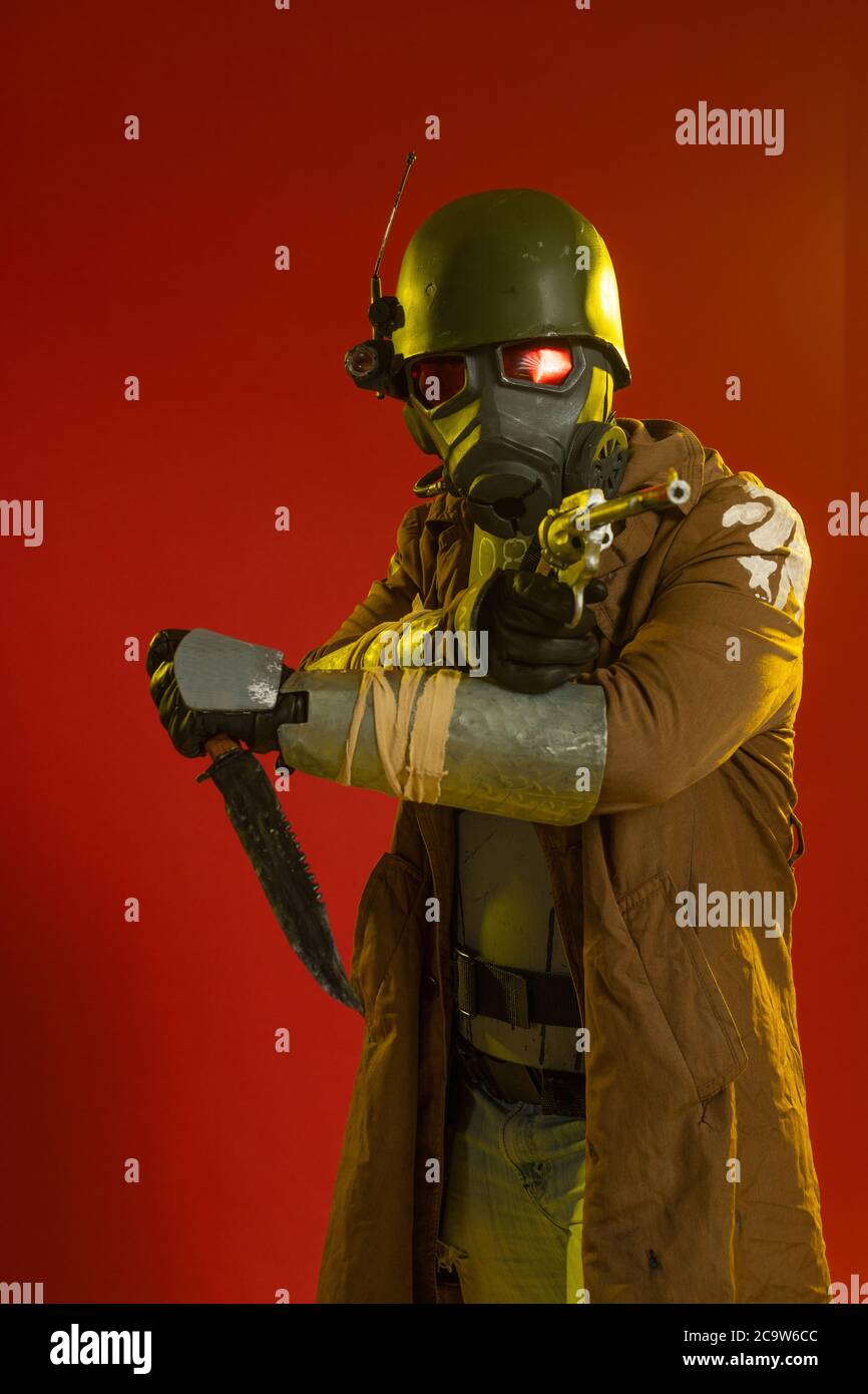 Actor man in a military helmet, mask and uniform posing on a red ...