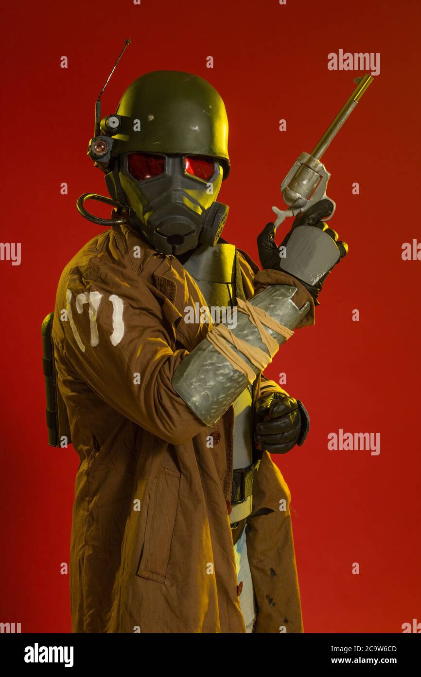 Actor man in a military helmet, mask and uniform posing on a red ...