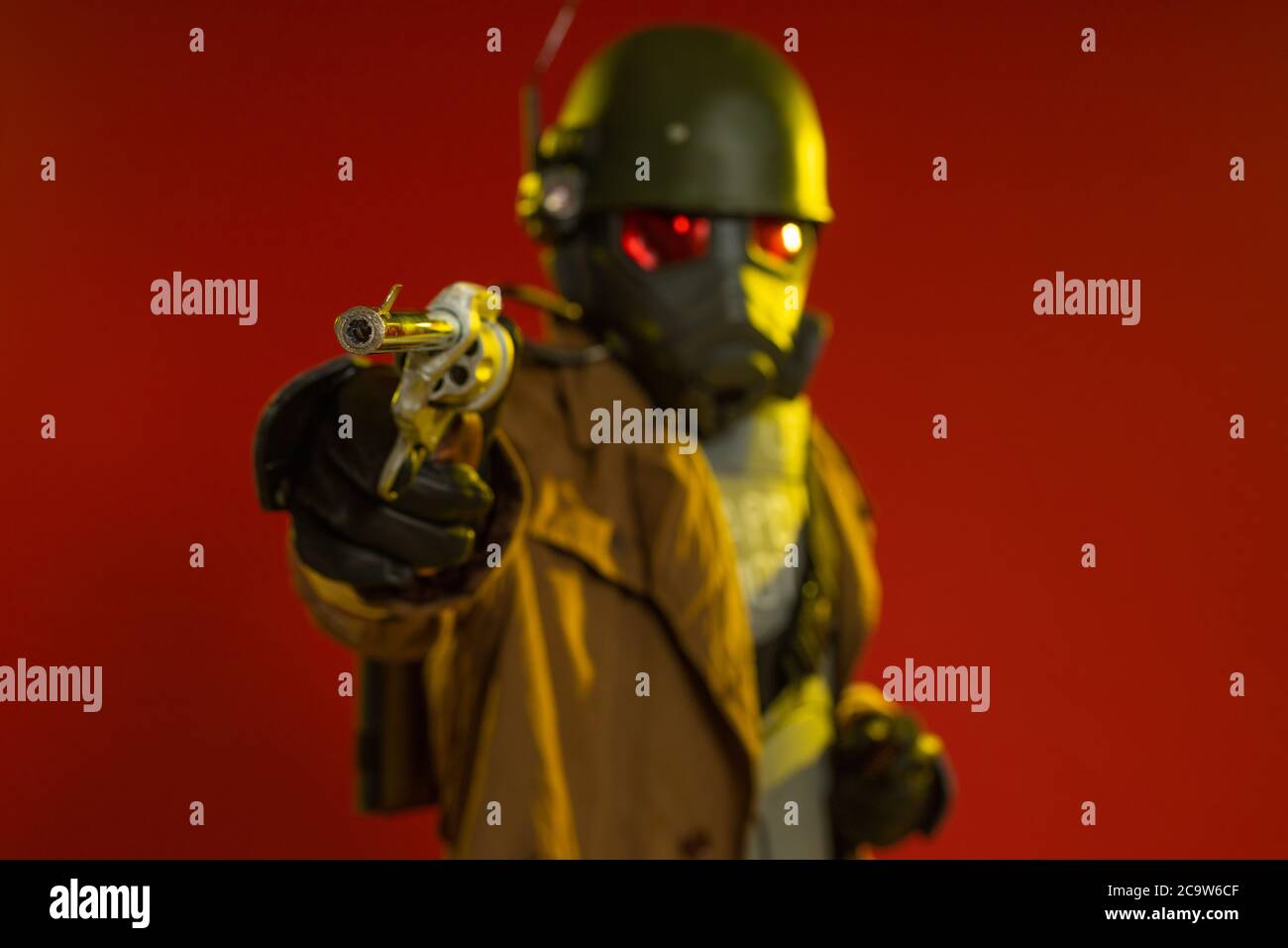 Actor man in a military helmet, mask and uniform posing on a red ...