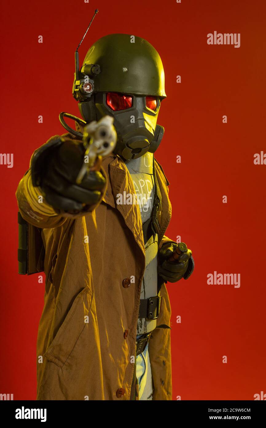 Actor man in a military helmet, mask and uniform posing on a red ...