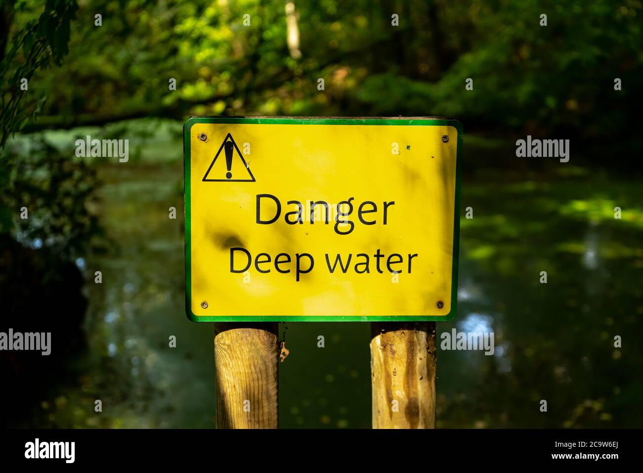 Yellow and black warning sign about deep water hi-res stock photography ...