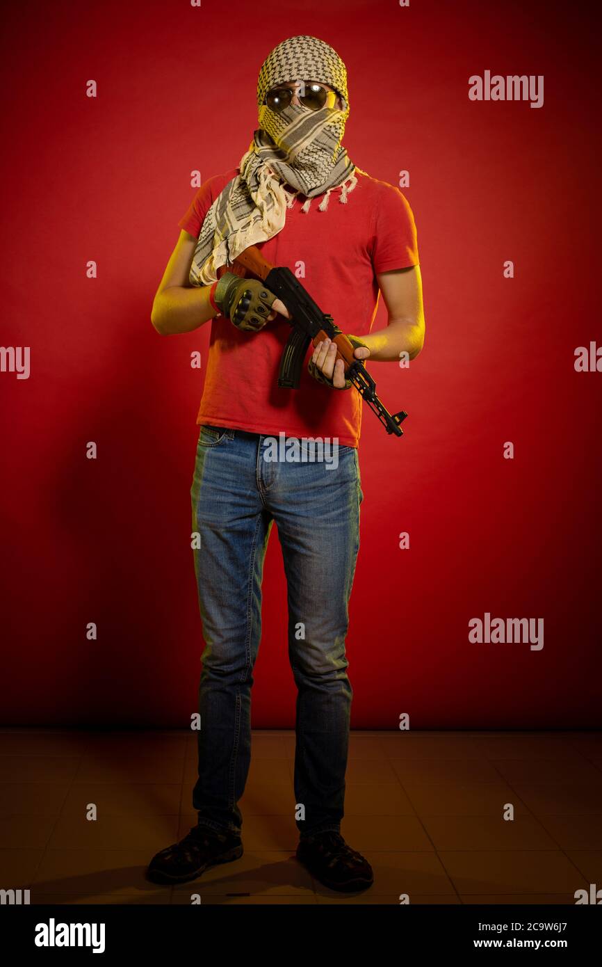Actor man in a military helmet, mask and uniform posing on a red ...