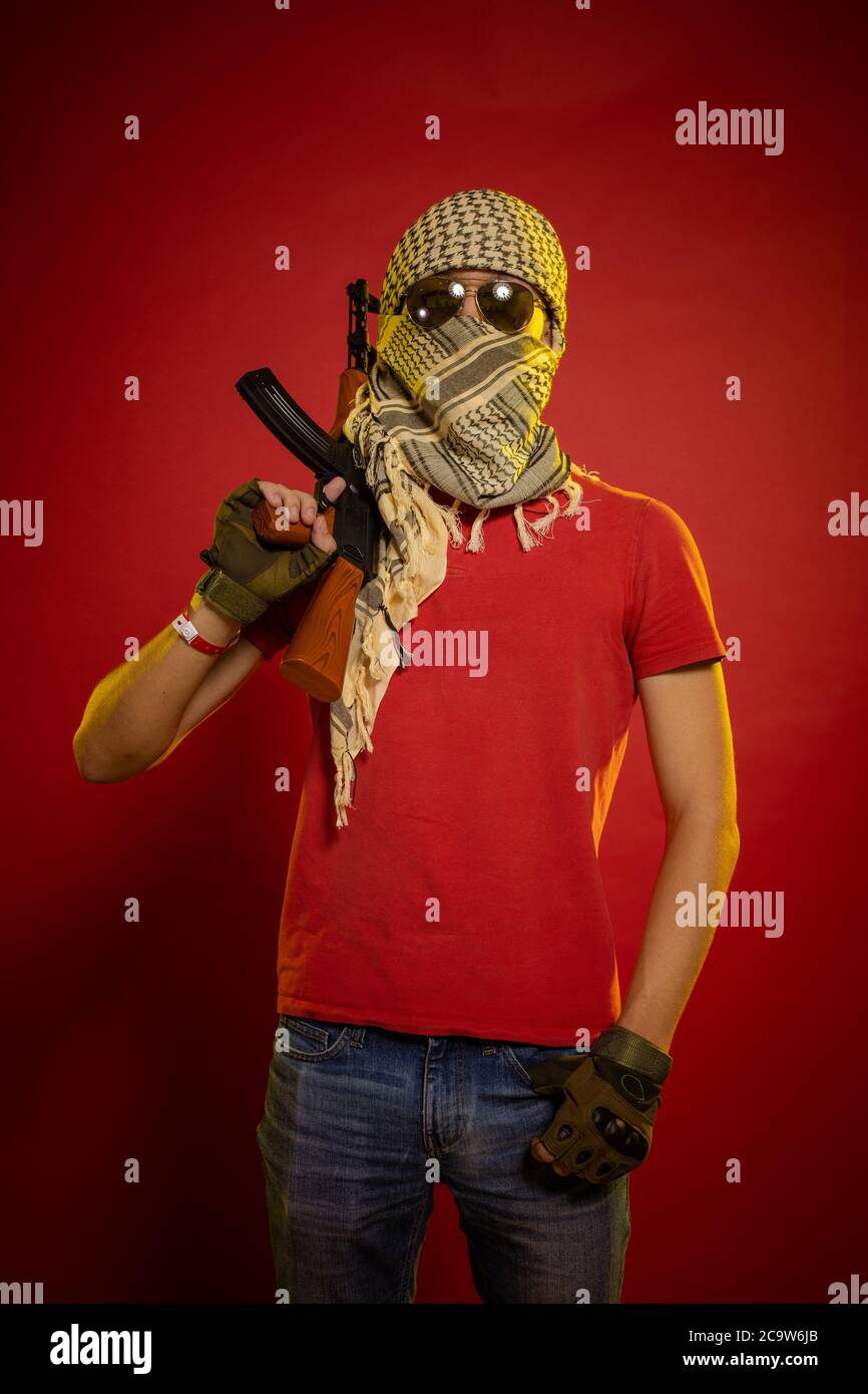 Actor man in a military helmet, mask and uniform posing on a red ...