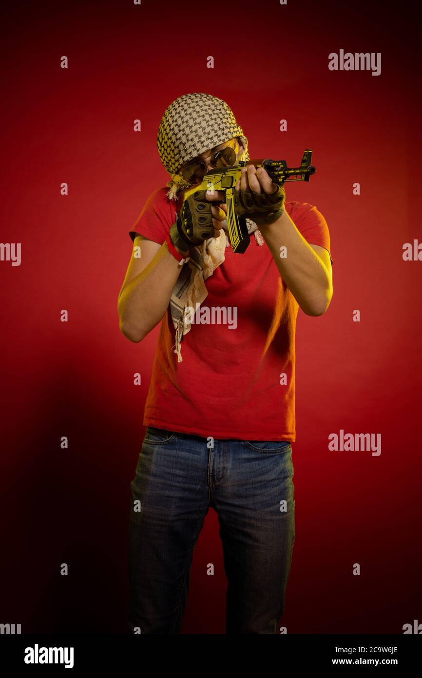 Actor man in a military helmet, mask and uniform posing on a red ...