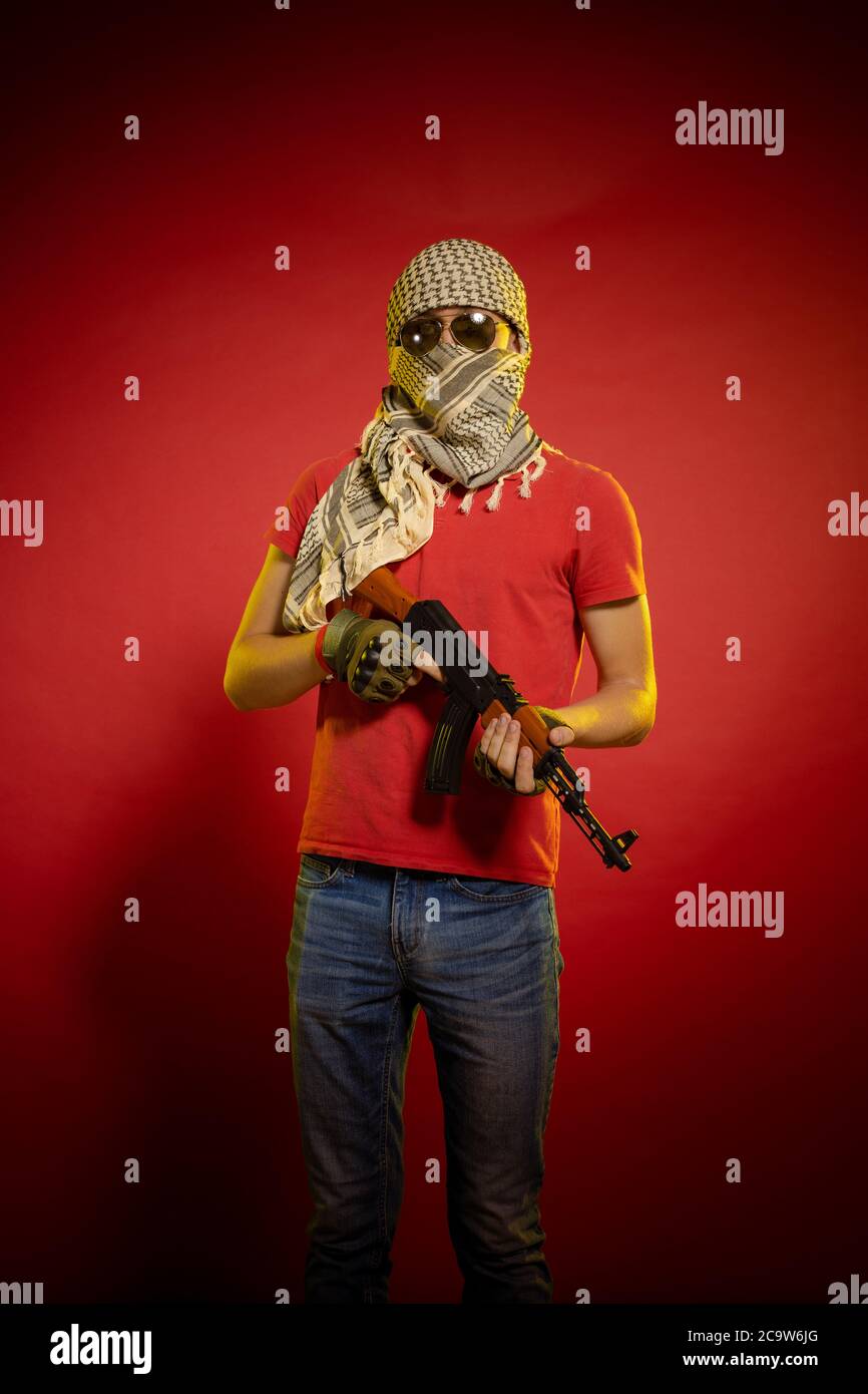 Actor man in a military helmet, mask and uniform posing on a red ...