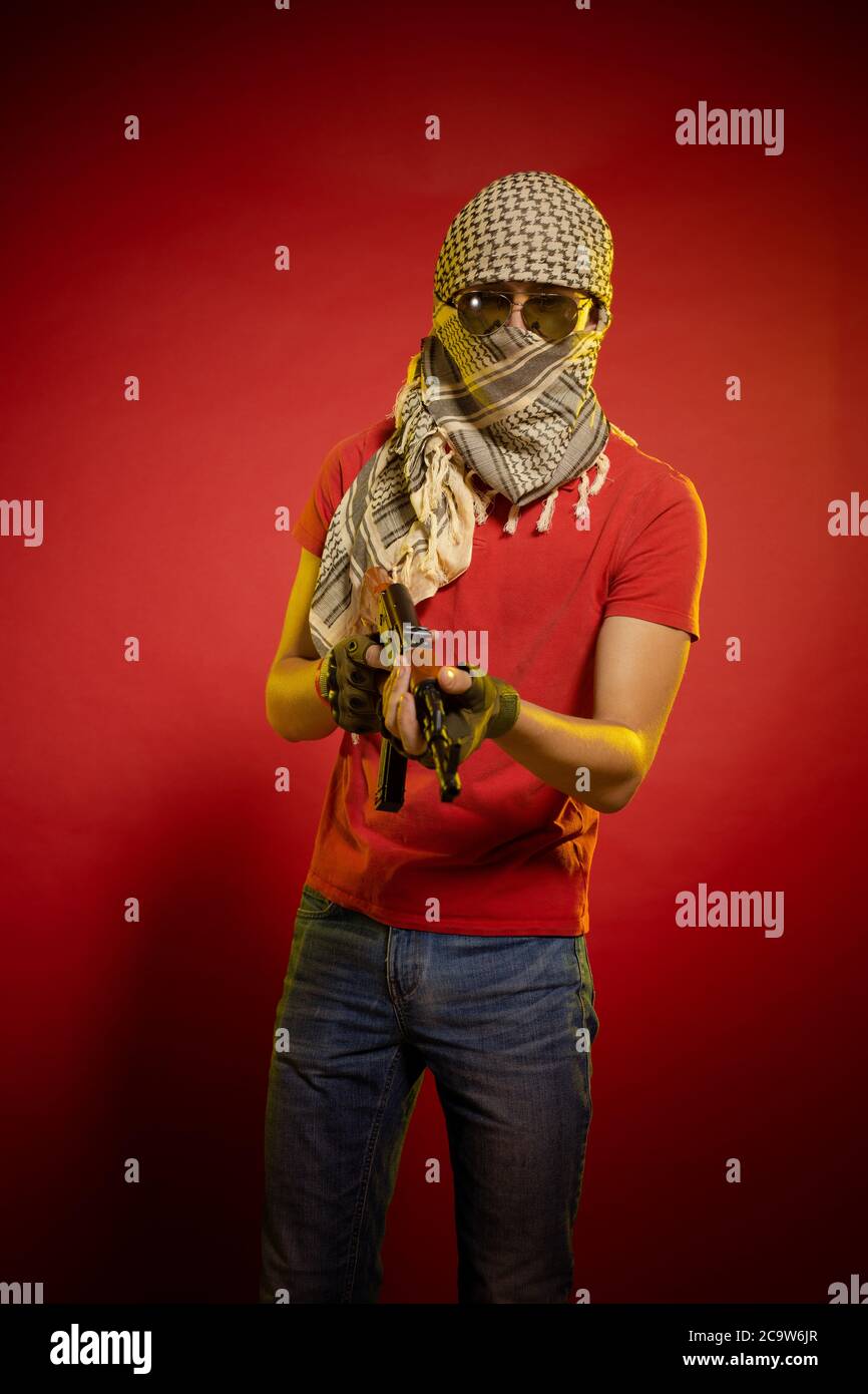 Actor man in a military helmet, mask and uniform posing on a red ...