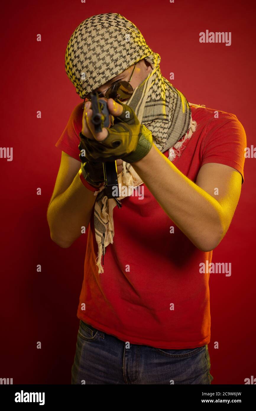 Actor man in a military helmet, mask and uniform posing on a red ...